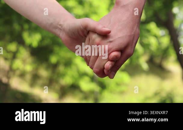 Close-up of two women's hands holding each other. Two women holding ...