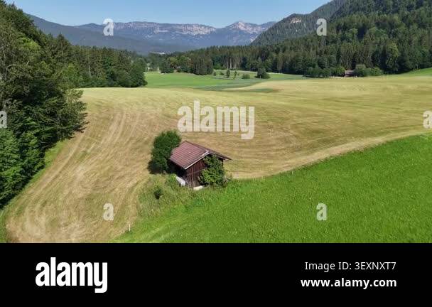 Picturesque landscape with a wooden house in the middle of a field ...