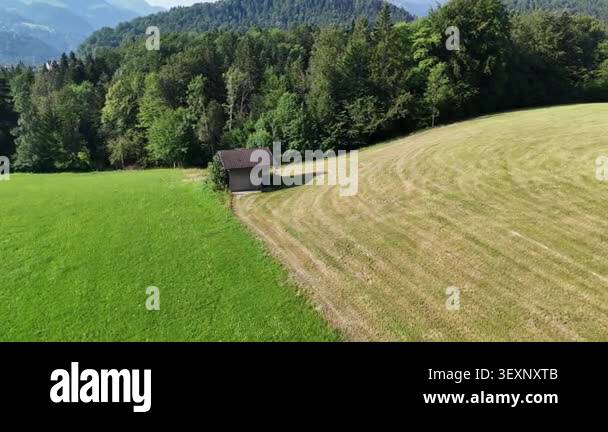 Picturesque landscape with a wooden house in the middle of a field ...