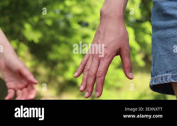 Two women holding hands. Close-up of two women's hands holding each ...