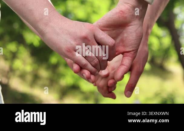 Close-up of two women's hands holding each other. Two women holding ...
