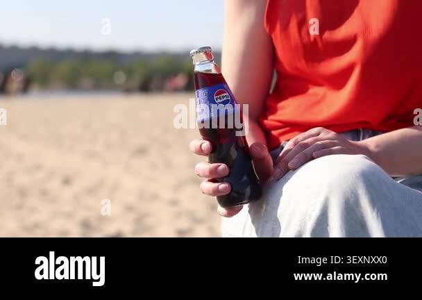 Kyiv, Ukraine - May 6, 2026: Young woman holding a glass bottle of ...