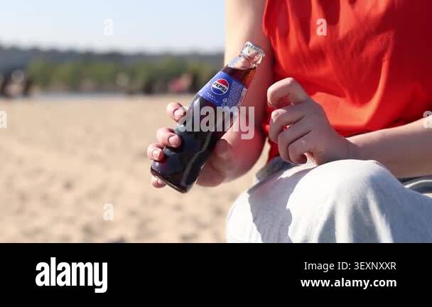 Kyiv, Ukraine - May 6, 2026: Young woman holding a glass bottle of ...