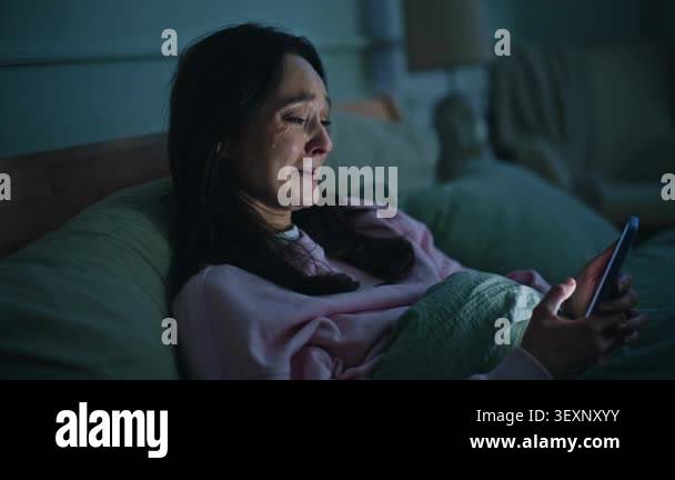 Sad woman crying bed night looking smartphone closeup. Stressed ...