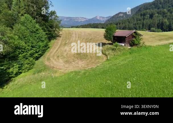 Picturesque landscape with a wooden house in the middle of a field ...