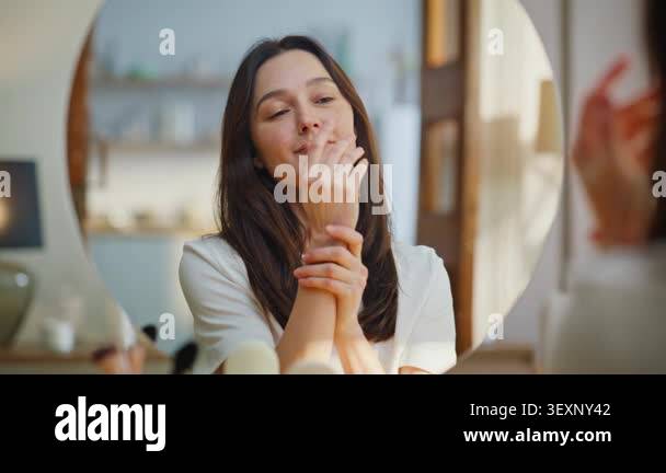 Brunette rubbing nourishing hand cream making soft massage carefully ...