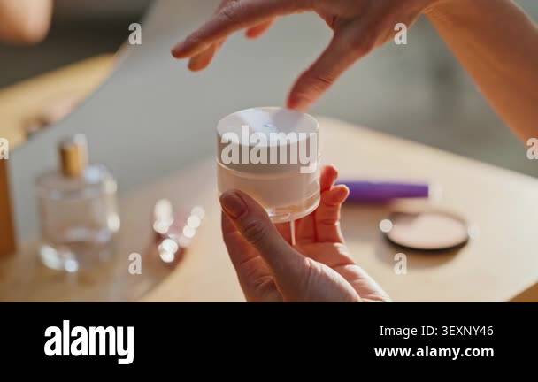Hands open face cream jar in home bathroom closeup. Unknown woman ...