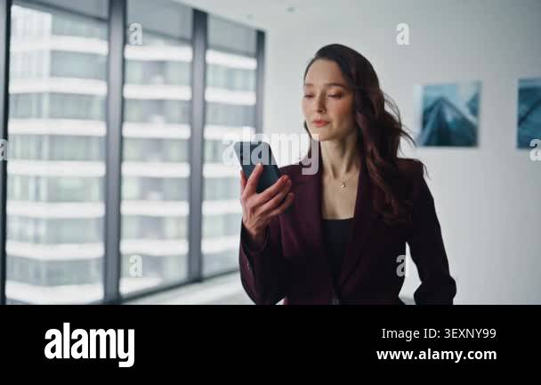 Luxurious lady watching smartphone reacting on win emotionally walking ...