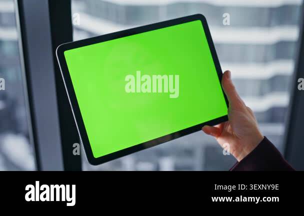 Online user holding mockup tablet at corporate panoramic office closeup ...