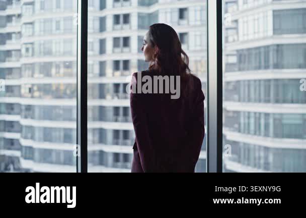Calm manager looking cityscape standing office room back view. Pensive ...