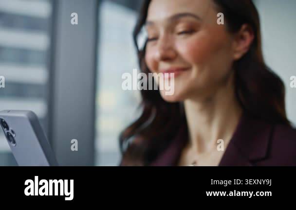 Director finger touching smartphone display standing office window ...