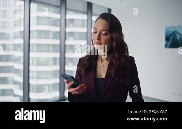 Relaxed businesswoman using smartphone indoors. Closeup smiling manager ...