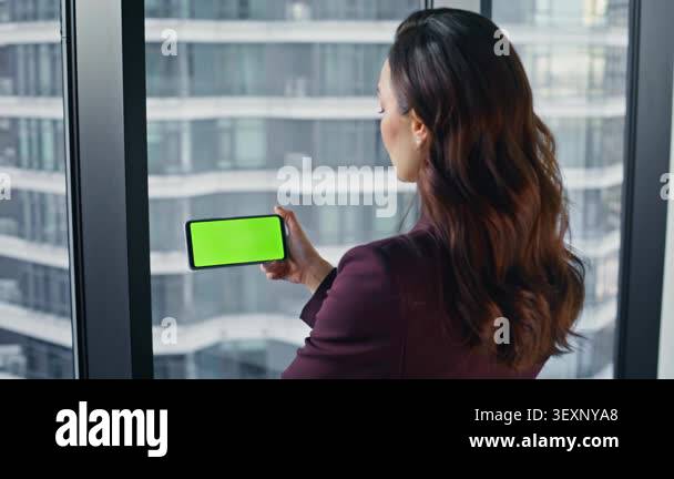 Boss hand holding chromakey cellphone working at panorama office ...
