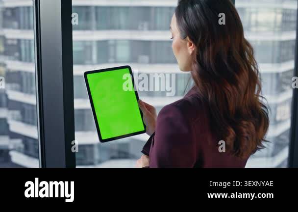 Office worker carrying mockup tablet at corporate workplace closeup ...