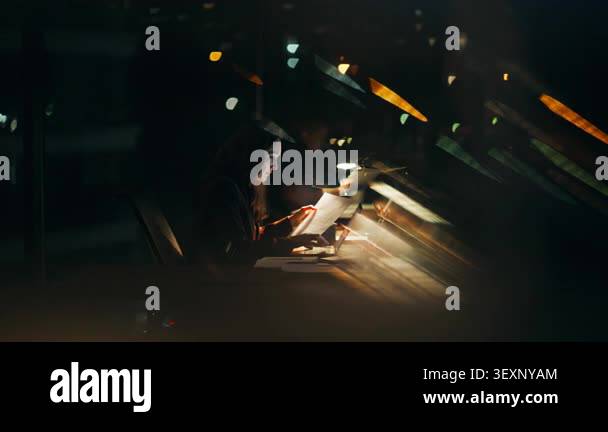 Overworked woman checking papers typing laptop at evening workspace ...