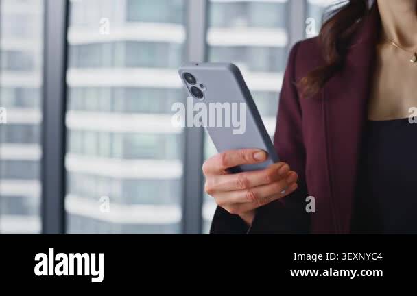 Lady hand using smartphone strolling office hall closeup. Young ...