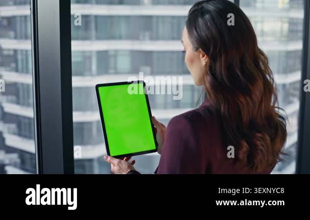 Office worker looking mockup tablet at cityscape workplace closeup ...