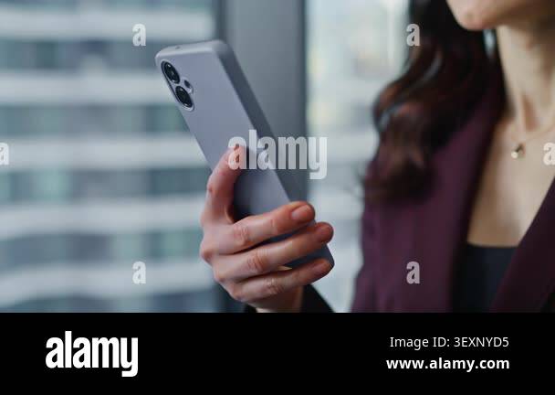 Boss finger tapping cellphone screen at cityscape office closeup ...
