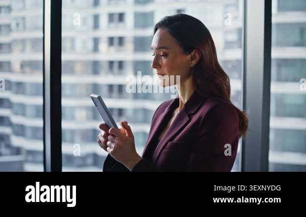 Elegant leader typing smartphone sending email by office panoramic ...