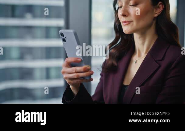 Closeup serious entrepreneur holding smartphone checking banking app ...