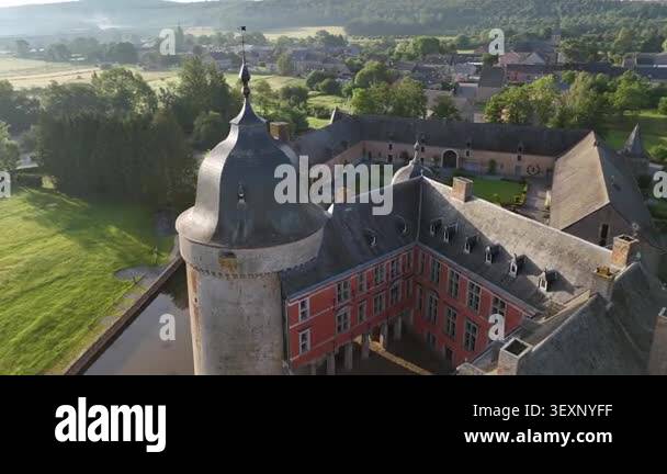 Flying above a moated castle in the Belgium Ardennes. The morning sun ...