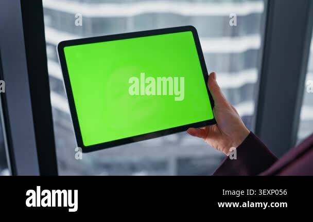 Businesswoman video calling mockup tablet in light cityscape office ...
