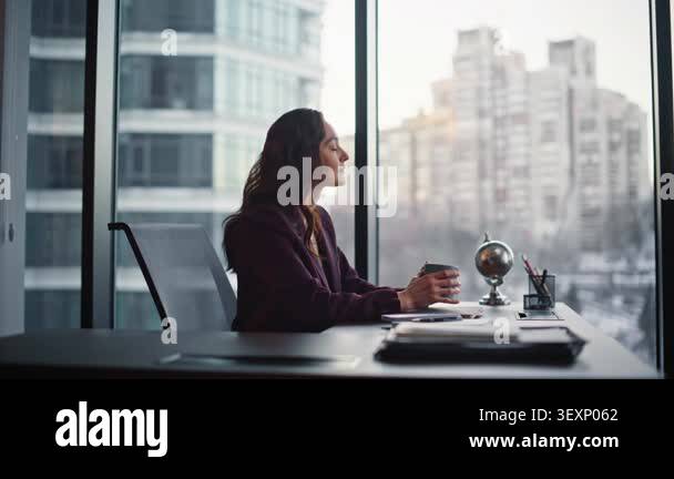 Relaxed businesswoman enjoy coffee break sitting modern office desk ...