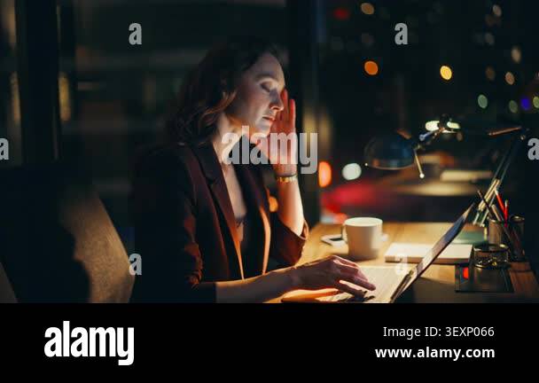 Overworked entrepreneur having migraine looking laptop at night ...