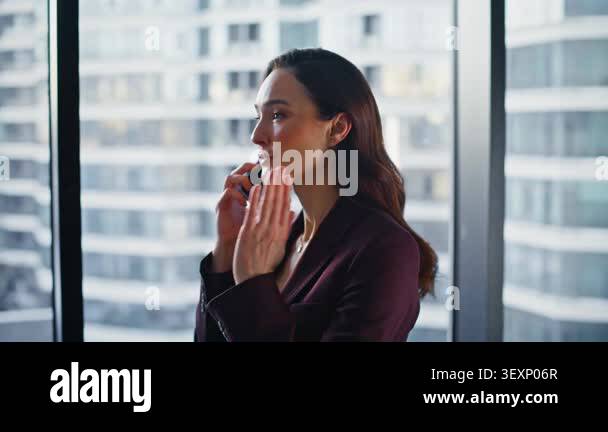 Positive female director calling at modern business center hall closeup ...