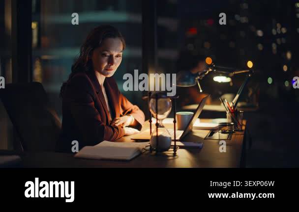 Overtime worker tracking time turning over glass clock at luxury ...
