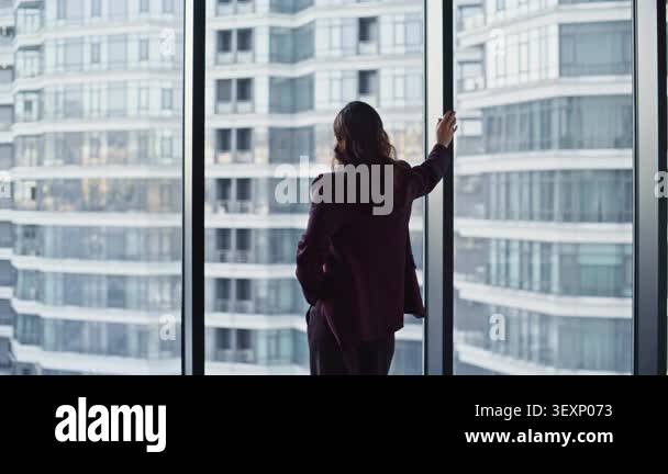 Confident leader standing panoramic office window thinking on business ...