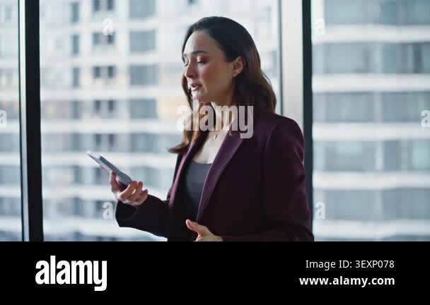 Shouting businesswoman calling cellphone at modern office building ...