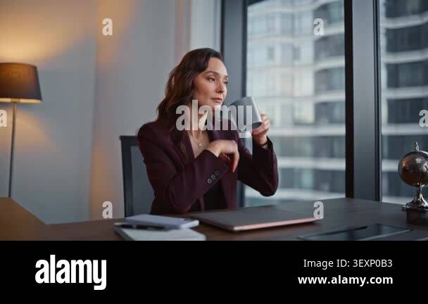 Entrepreneur taking coffee break sitting office desk before laptop work ...