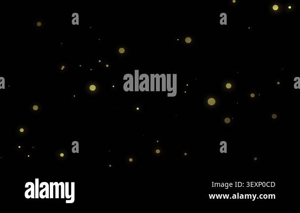 Golden glitter luxurious particles floating on a black background ...