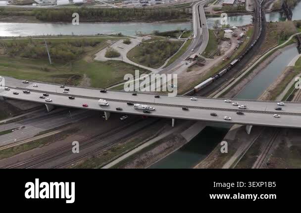 A stunning 4K aerial drone view of a long freight train traveling ...