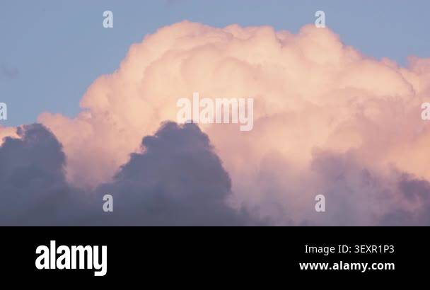 Cumulonimbus storm clouds forming in sunset sky with birds flying fast ...