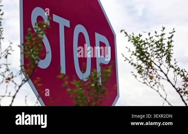Red stop sign on road intersection, traffic control Stock Video Footage ...