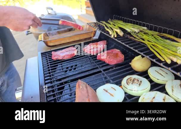 Meat and vegetables cooking on barbecue grill outdoors, California, USA ...