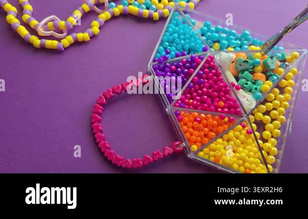 Brightly colored sets of beads, seed beads, and decorative elements in ...