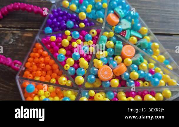 Brightly colored sets of beads, seed beads, and decorative elements in ...