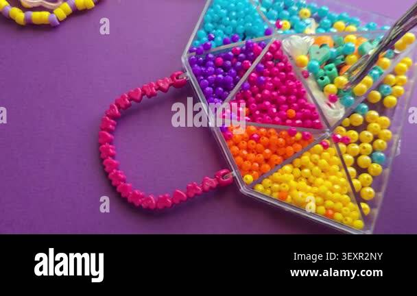 Brightly colored sets of beads, seed beads, and decorative elements in ...