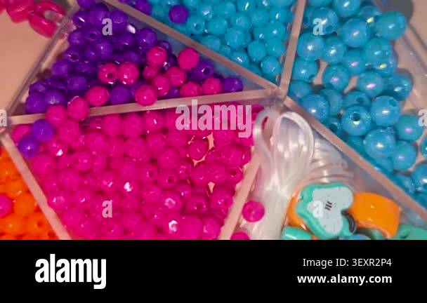 Brightly colored sets of beads, seed beads, and decorative elements in ...