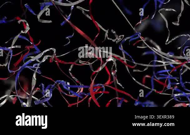 Metallic party streamers float, twist, and swirl in slow motion as the ...