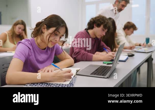 High school students concentrating on a test while writing in their ...