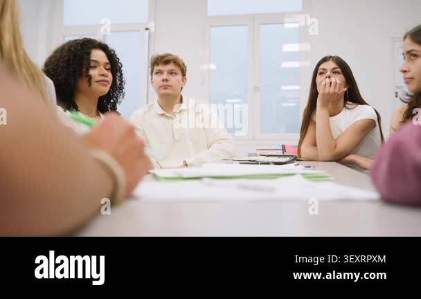 Multiethnic group of young university students collaborating on a ...