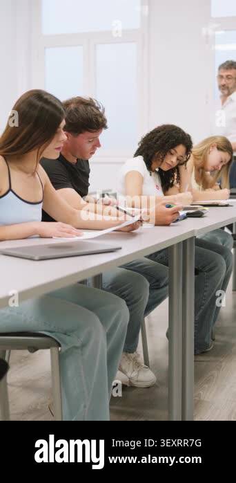 Group of diverse college students writing and concentrating on a test ...