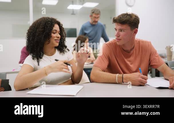 Young diverse college students interacting and working together during ...