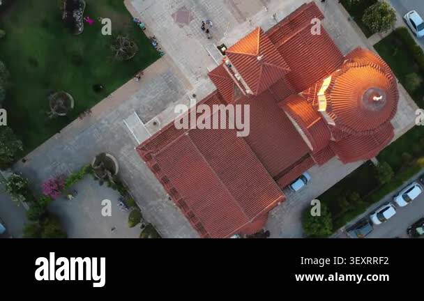 Aerial vertical shot showing tiled church roofing, a courtyard, green ...