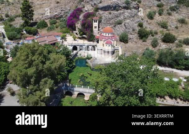Aerial wide angle footage presents a traditional church, arched stone ...