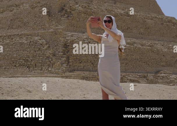 Slow motion 4K travel video of a female tourist taking a selfie with a ...
